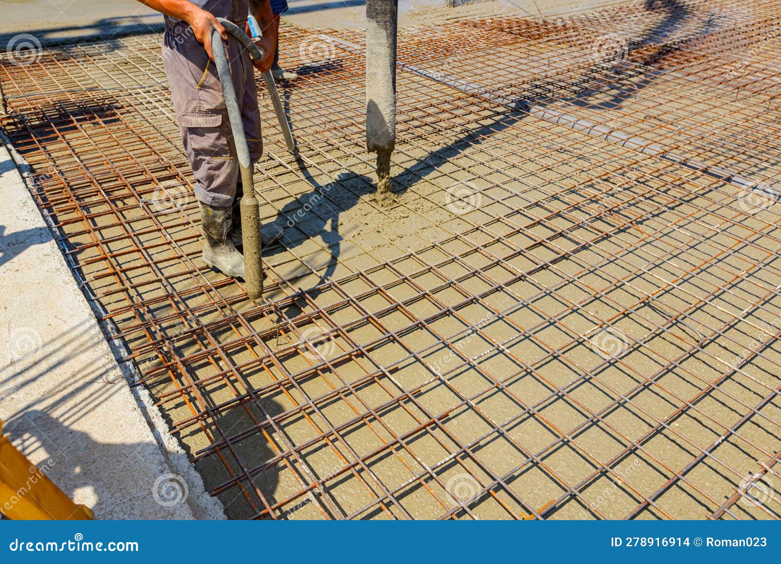 Worker is Using Electric Vibratory To Compact Concrete in Foundation ...