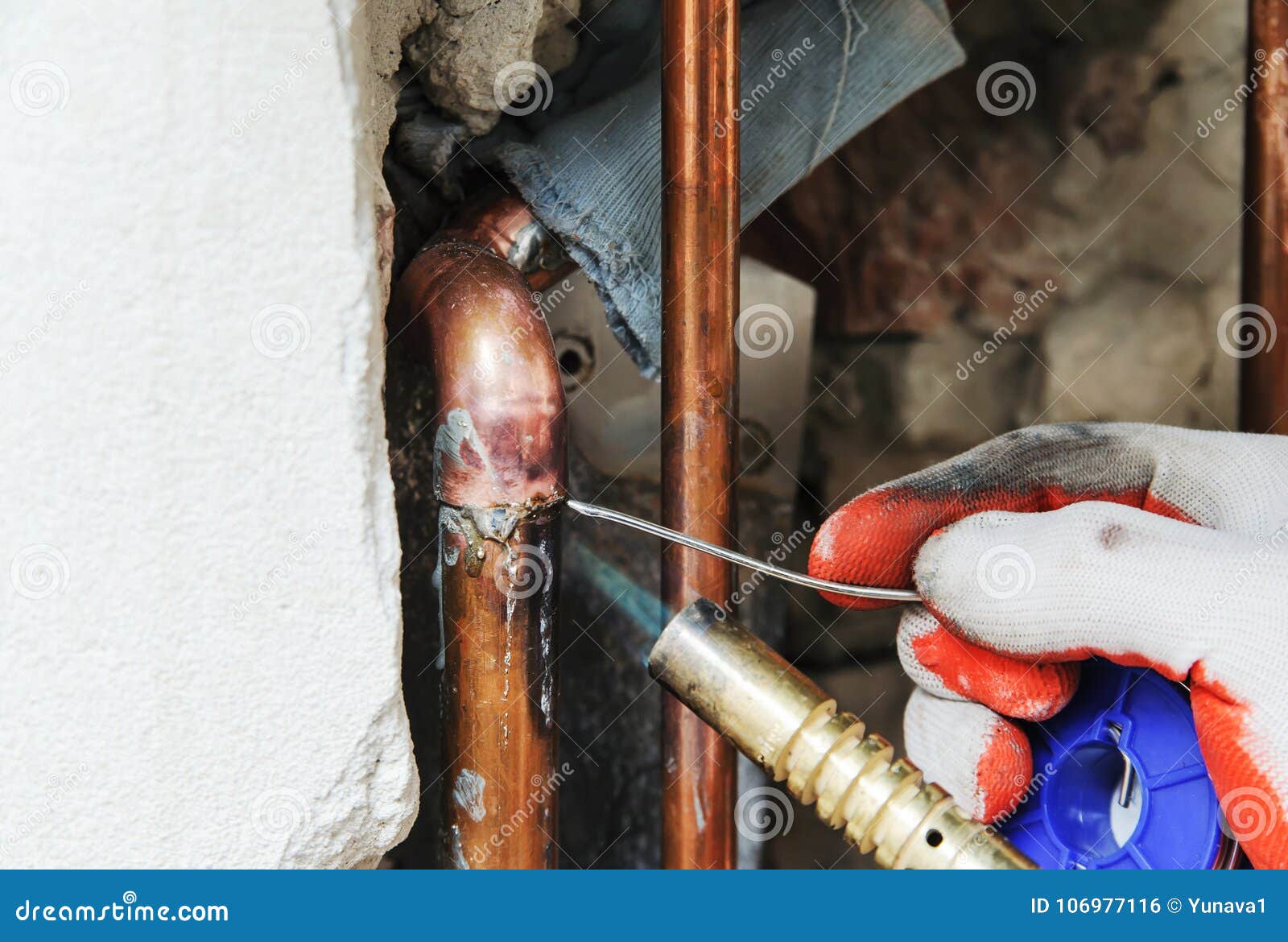 A Worker is Soldering Copper Pipes. Stock Photo - Image of spanner ...