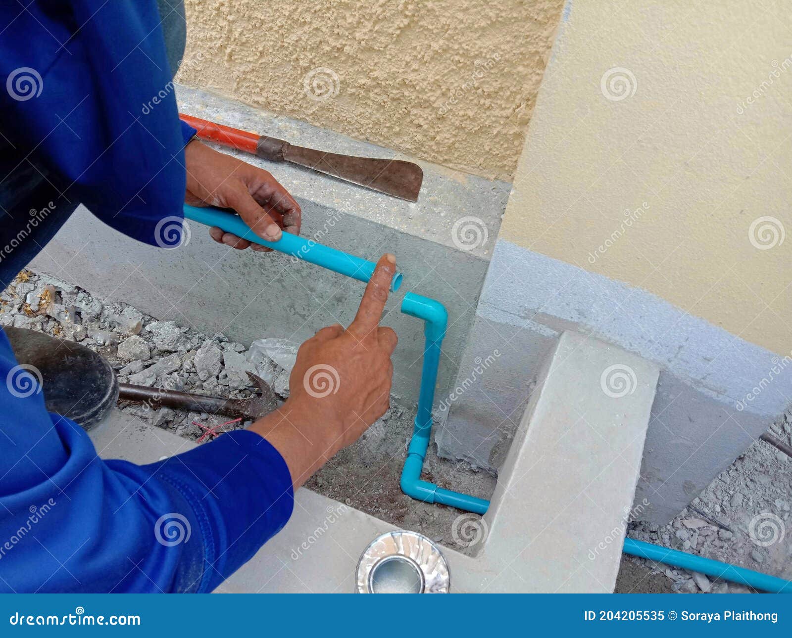 Worker is Using Glue with Pipe Fitting for Installing the Blue PVC ...