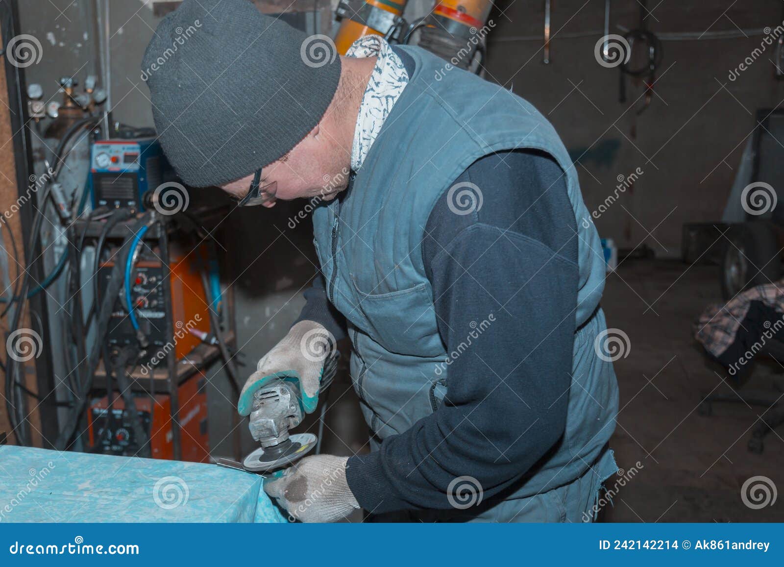 The Hands of a Locksmith Process the Part with a Grinder Stock Photo ...