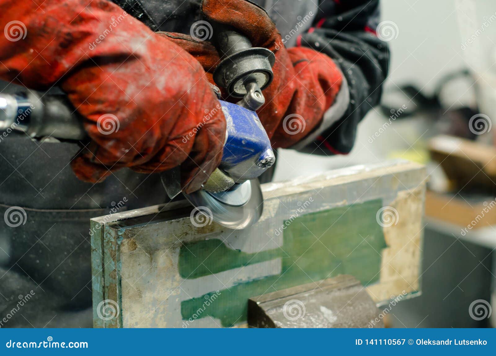 Worker using a grinder stock image. Image of construction - 141110567