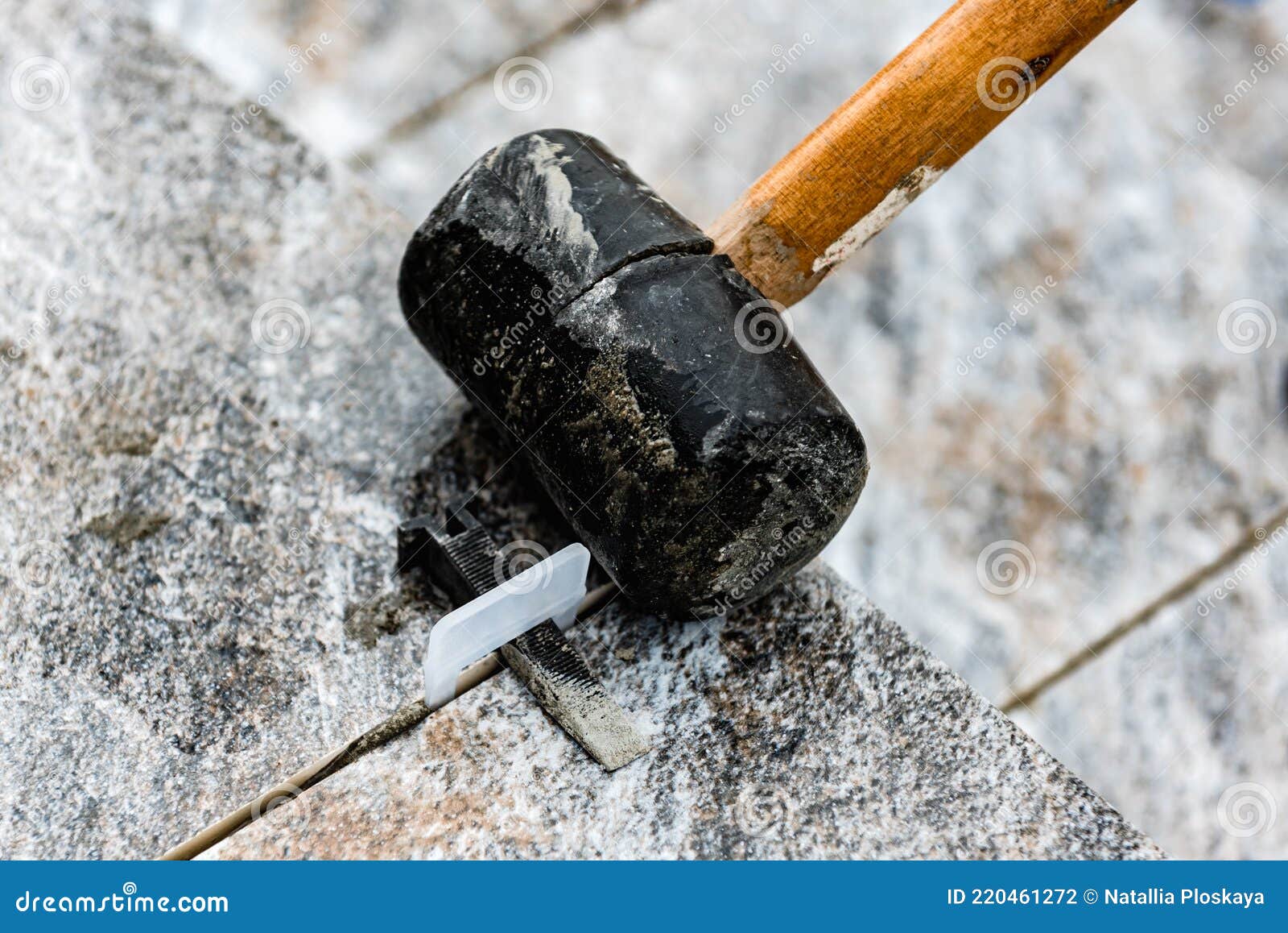 Worker Using Hammer for Removing Tile Leveling System with Plastic ...