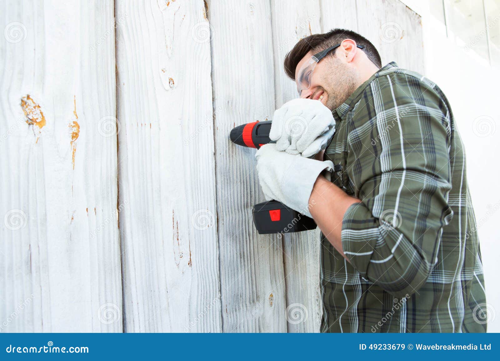 Worker Using Hand Drill on Wooden Cabin Stock Image - Image of ...