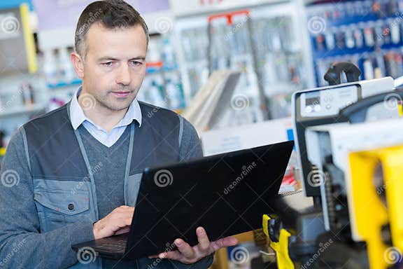 Worker Using Laptop To Order Stock Photo - Image of laptop, design ...