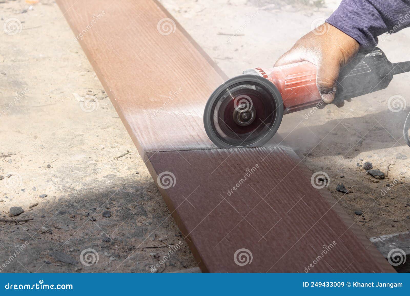 A Worker is Using a Lumber Cutter. Hands of People Working Cutting ...