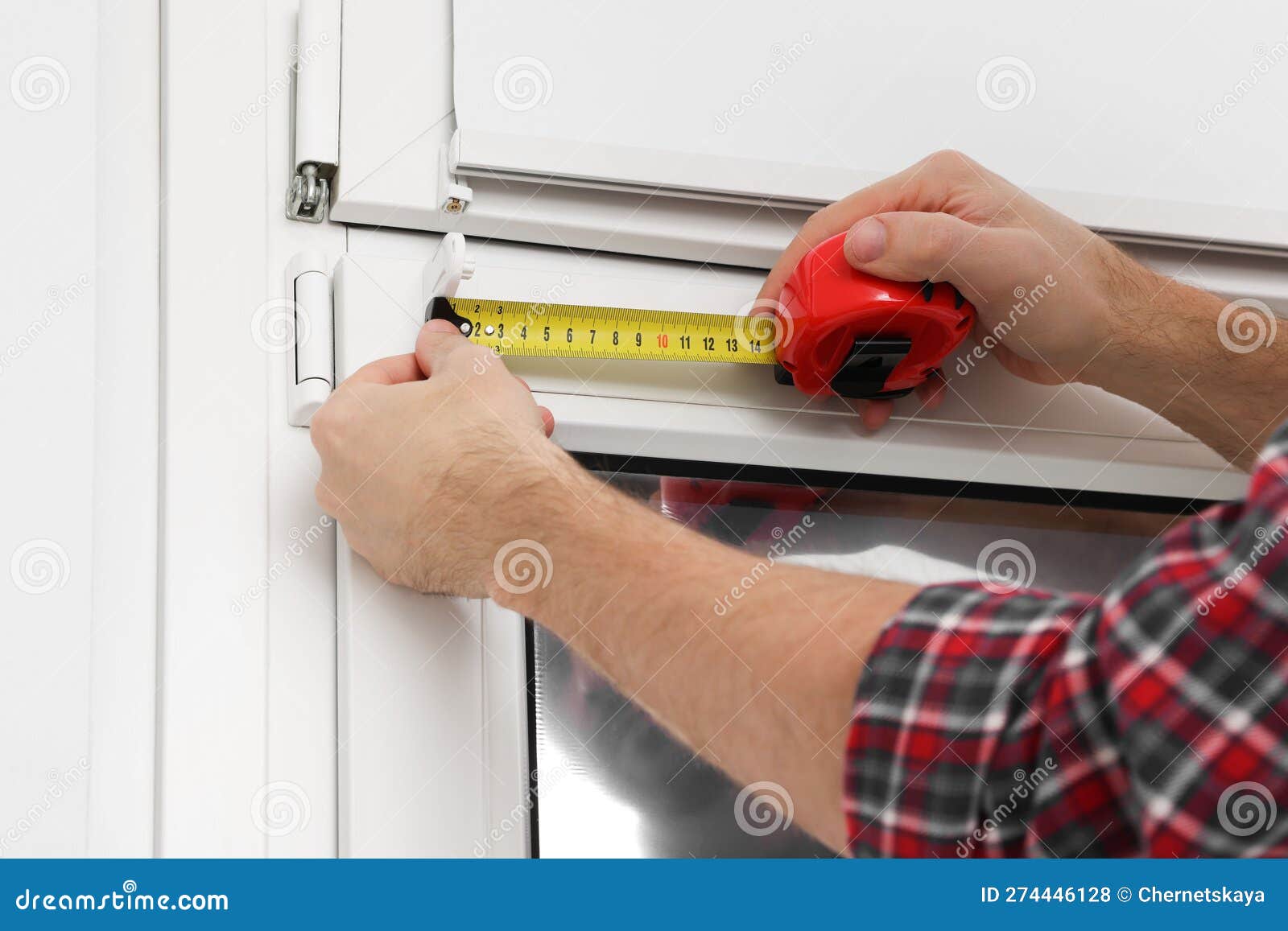 Worker Using Measuring Tape while Installing Roller Window Blind ...