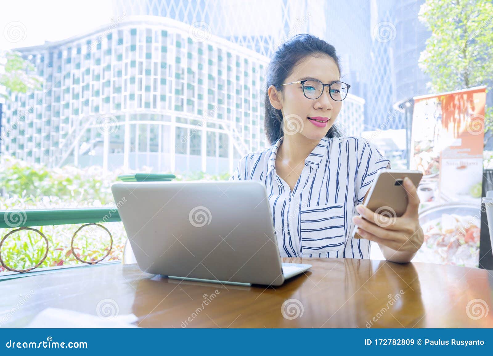 Worker Using Mobile Phone and Laptop in Cafe Stock Image - Image of ...
