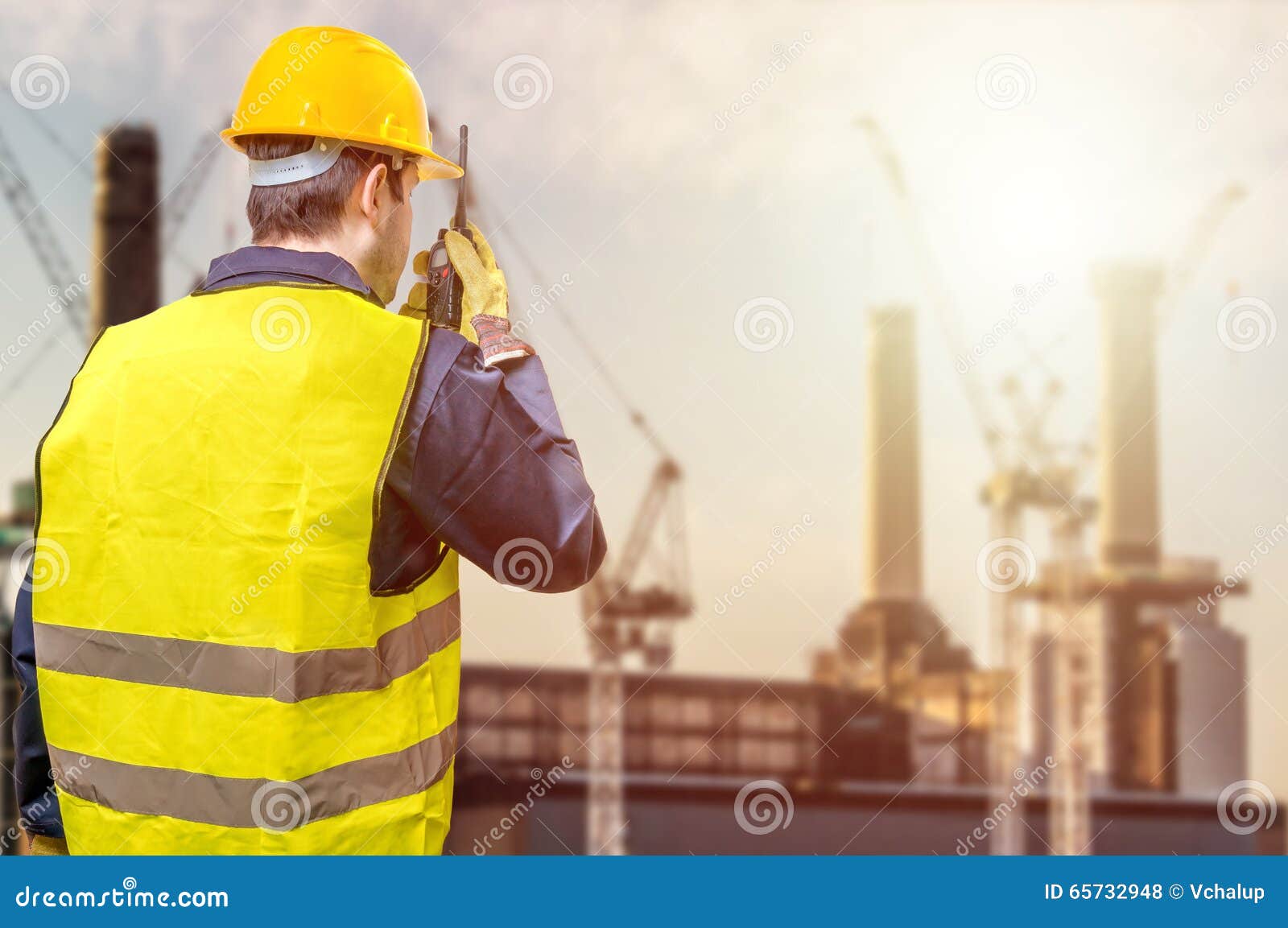 Worker is Using Radio and Crane Site during Sunset. Construction Stock ...