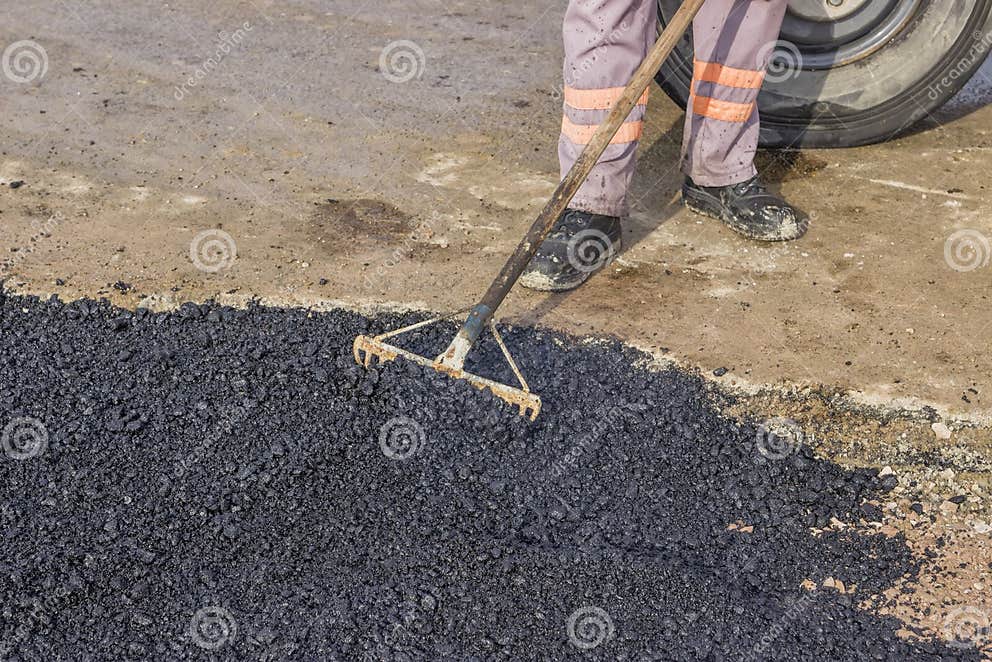 Worker Using Rake To Level Asphalt Pavement Stock Photo - Image of ...
