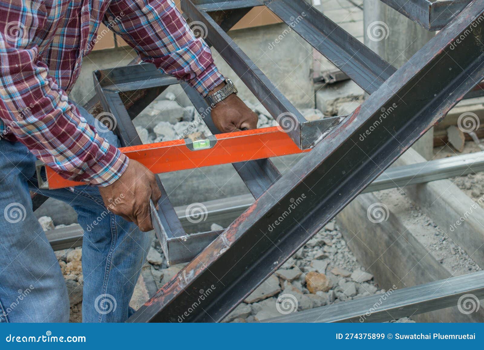Worker Using Spirit Level Tool for Checking the Level of Steel Stock ...