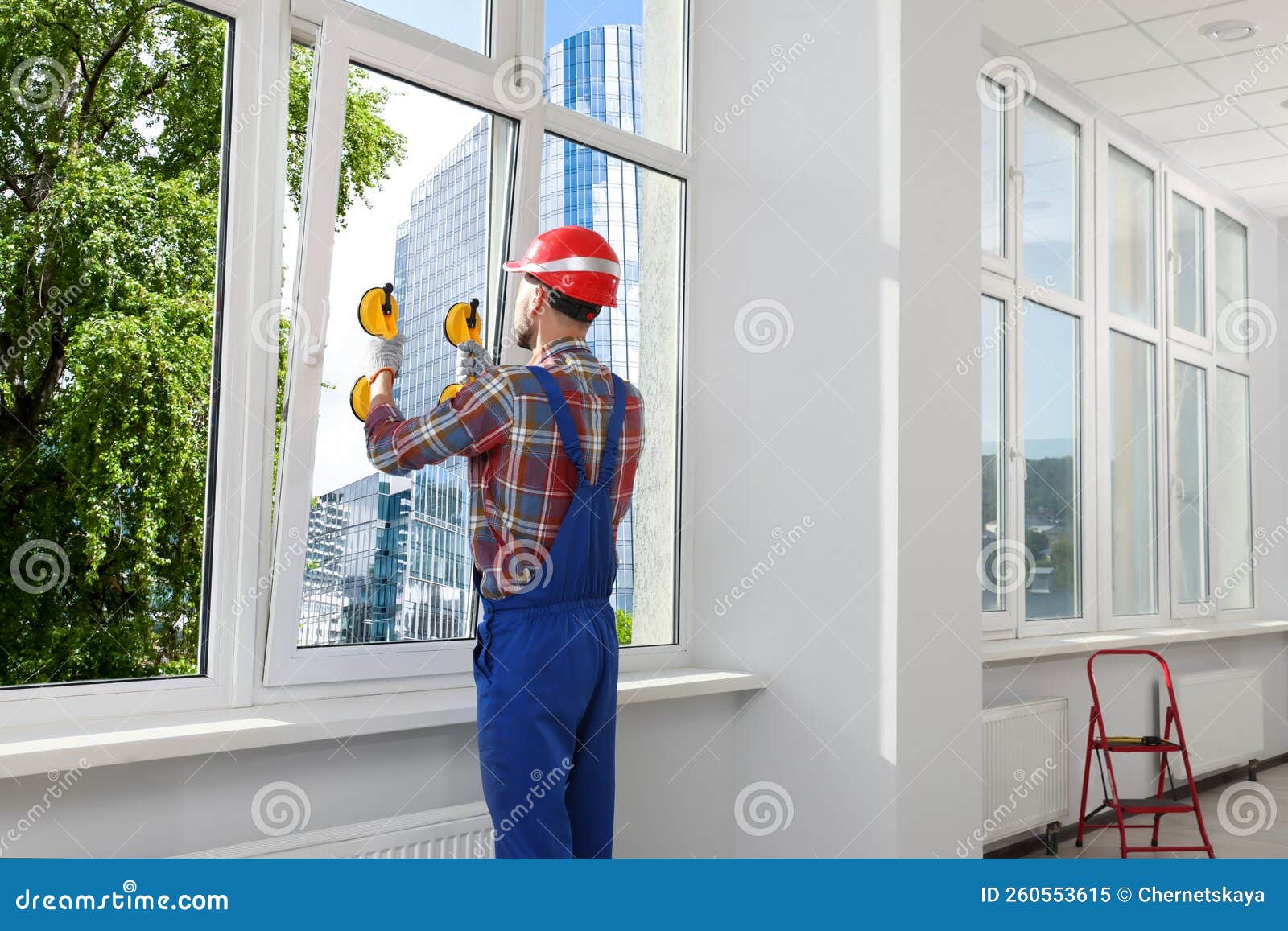 Worker Using Suction Lifters during Plastic Window Installation Indoors ...