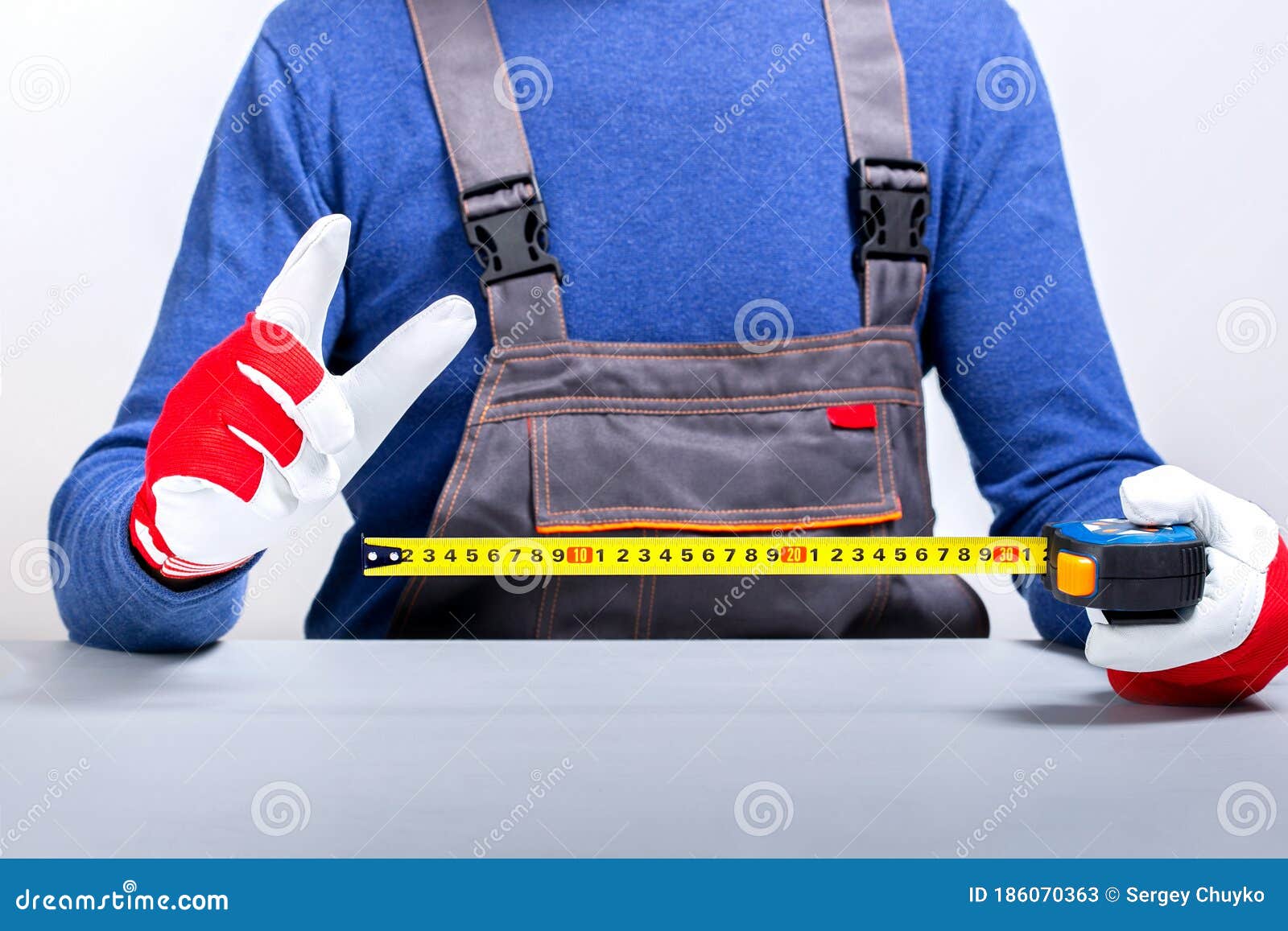 Worker Using Tape Measure stock image. Image of hand - 186070363