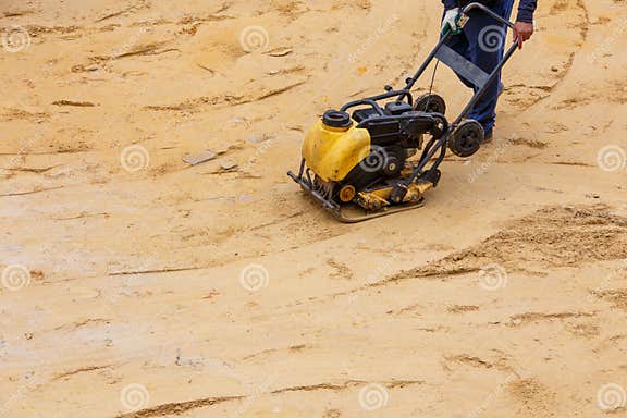 Worker Using Vibratory Plate Compactor for Compaction Sand during Path ...