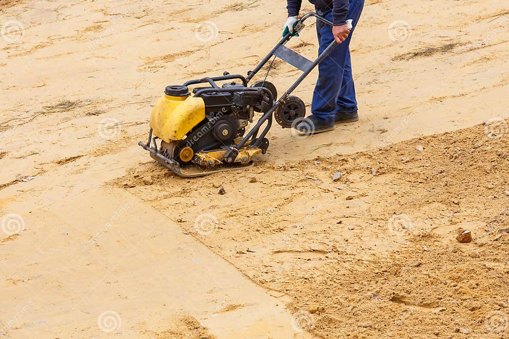 Worker Using Vibratory Plate Compactor for Compaction Sand during Path ...
