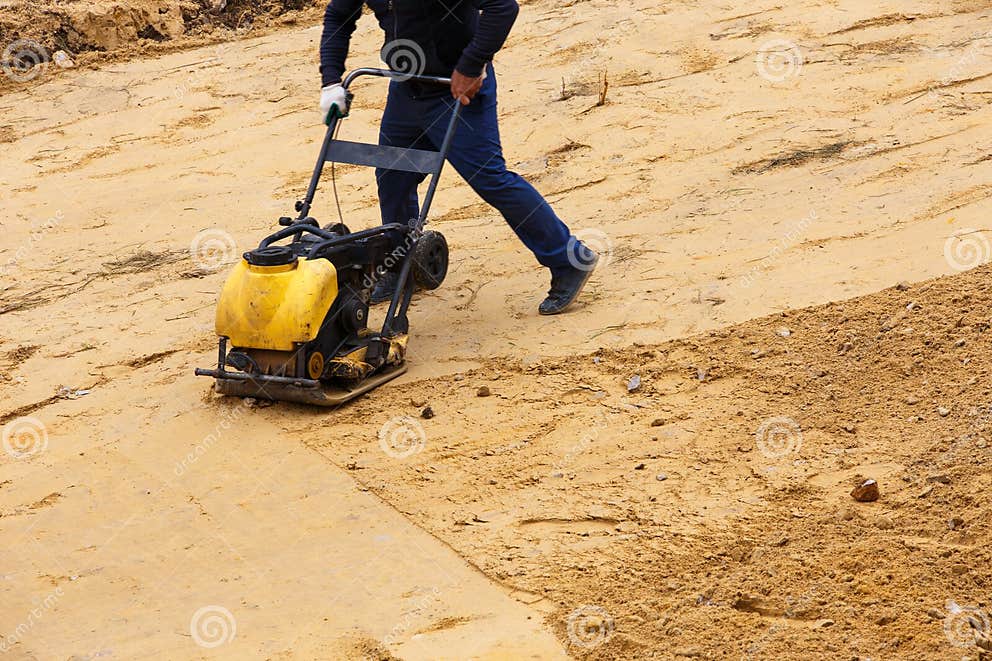Worker Using Vibratory Plate Compactor for Compaction Sand during Path ...