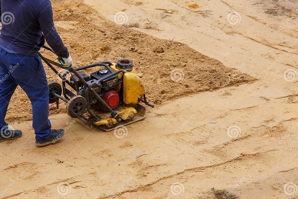 Worker Using Vibratory Plate Compactor for Compaction Sand during Path ...