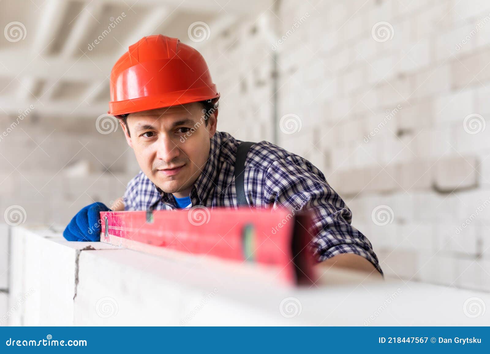 Worker Using Water Level Meter Measuring the Wall Builder Working with ...