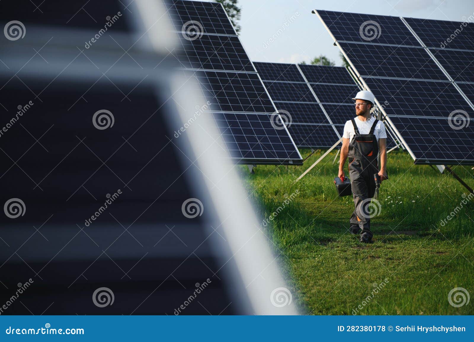 A Worker Walks through a Solar Panel Farm Stock Photo - Image of ...