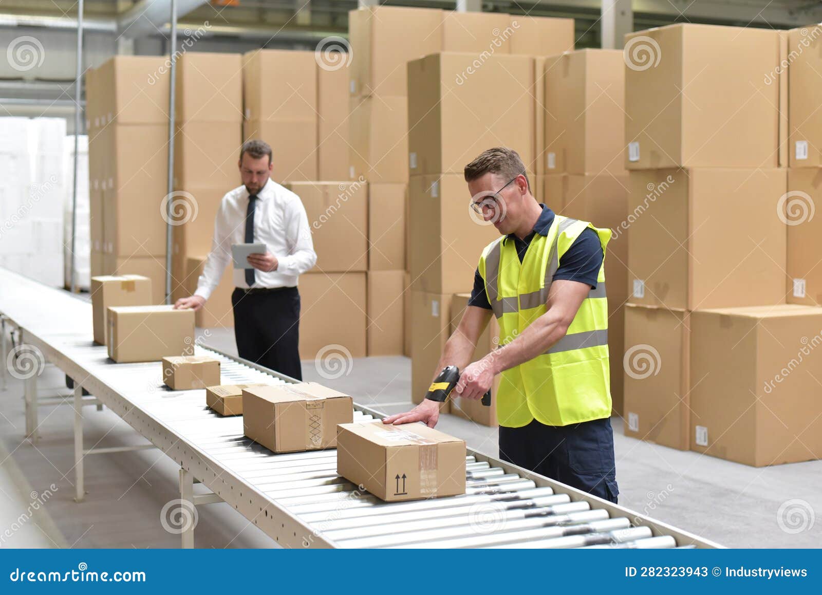 Worker in a Warehouse in the Logistics Sector Processing Packages on ...