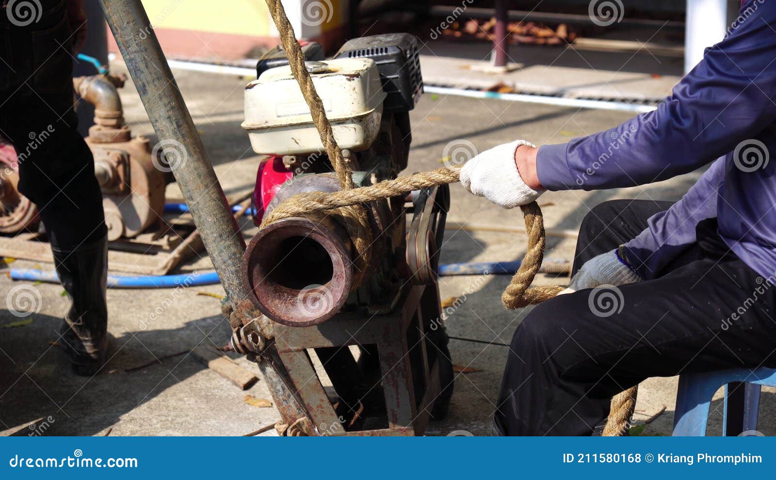 Worker Was Pulling the Rope from on Pulleys of Engine. Stock Photo ...