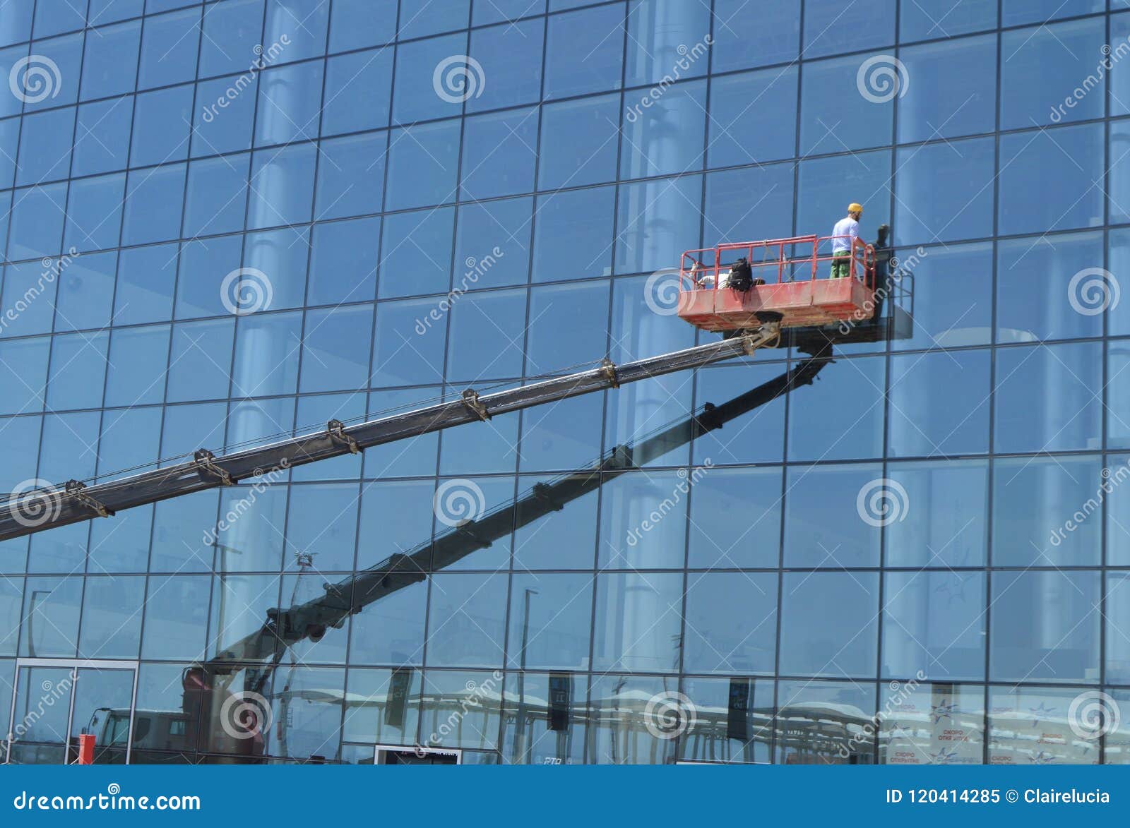 Worker Washes The Windows On The Glass Facade Of A Skyscraper, Standing ...