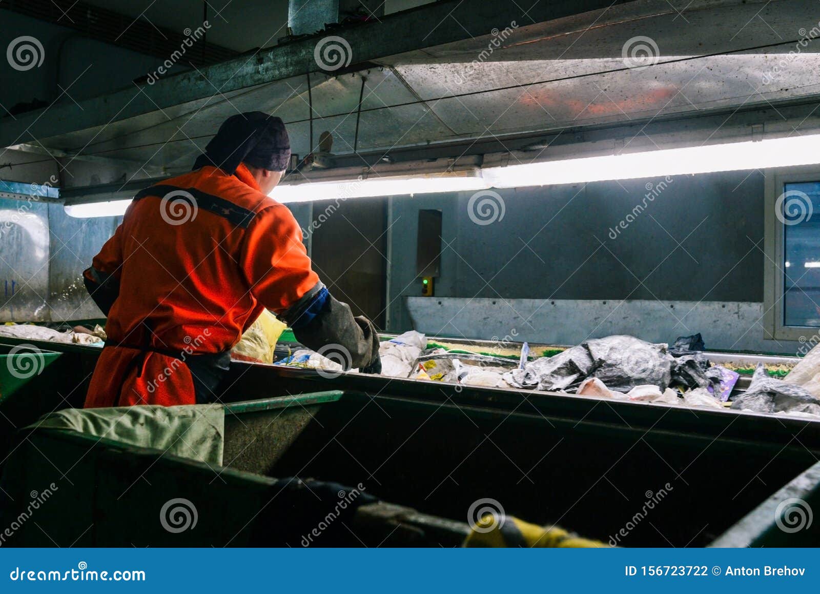 Worker at a Waste Processing Plant. a Man Sorts Rubbish with His Hands ...