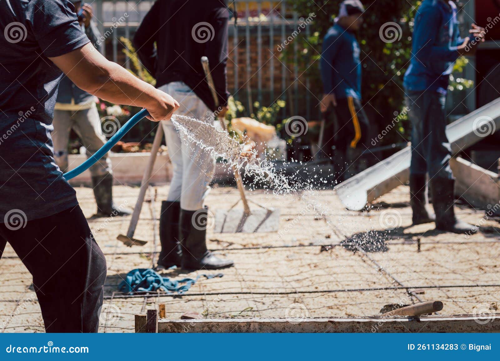 Worker Watering Ground Preparing the Concrete in the Foundation. Stock ...