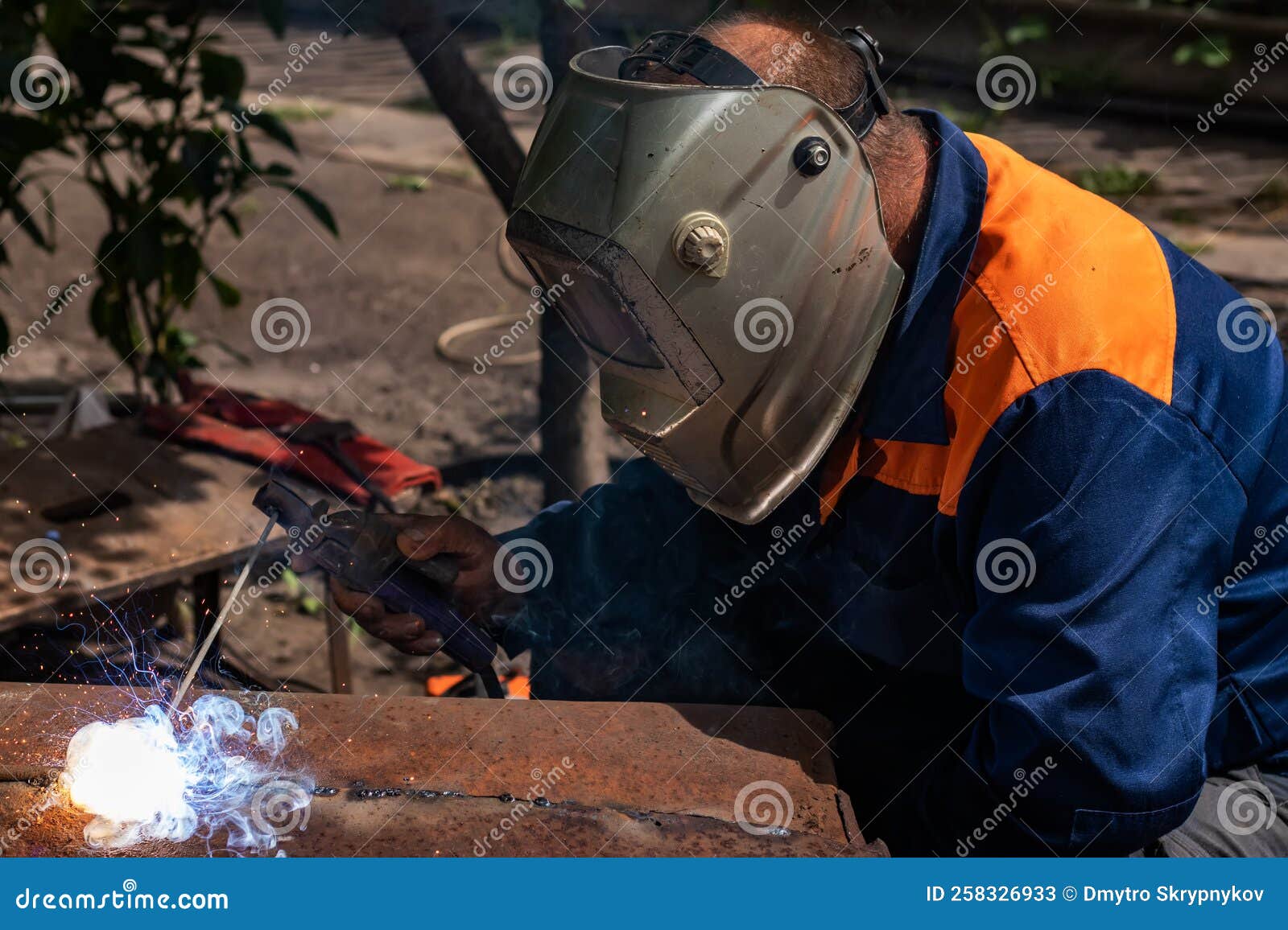Worker Wearing Industrial Uniforms and Welded Mask Industrial Safety ...