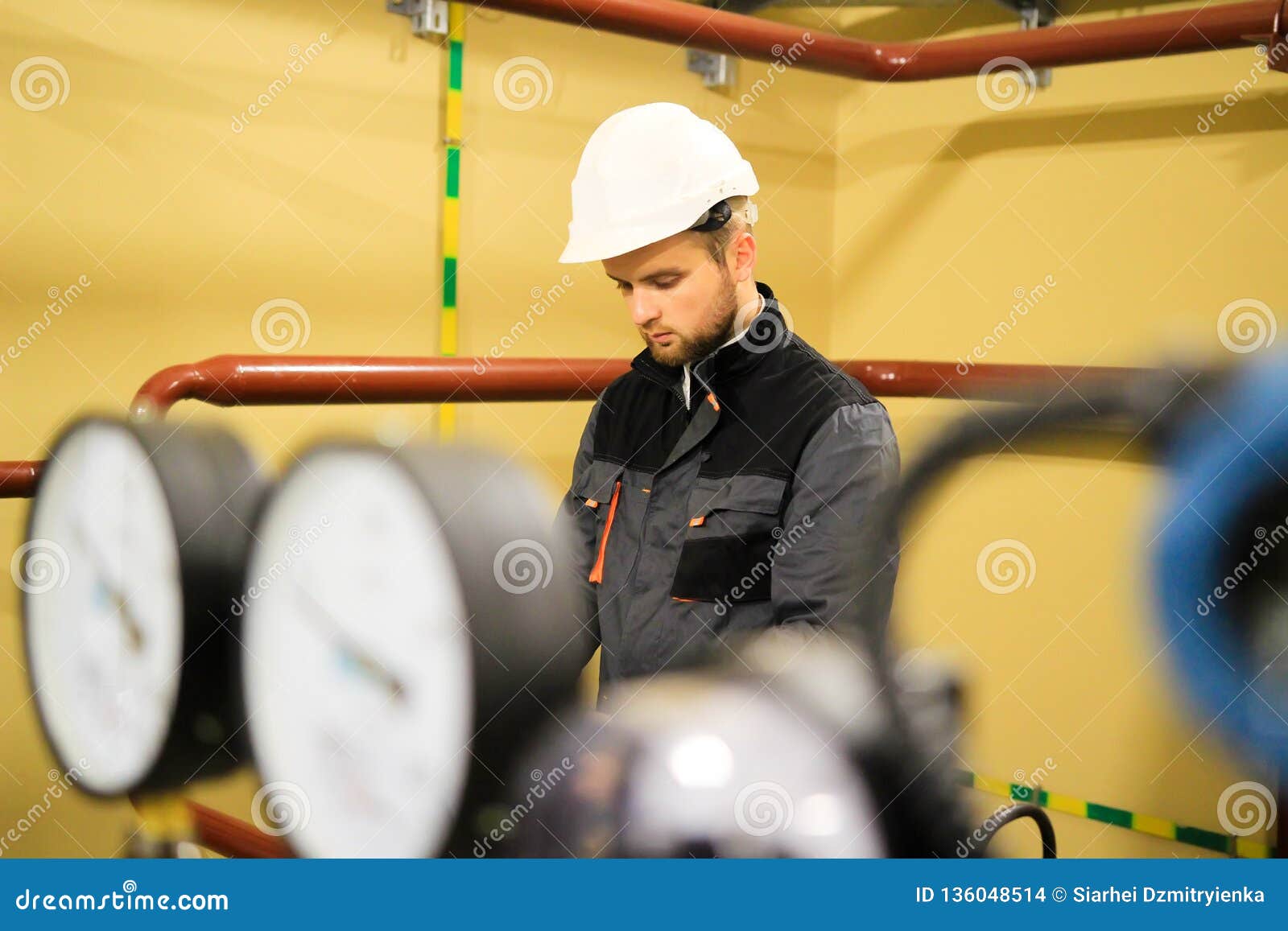 Worker Wearing Overalls and Protective Helmets Stock Photo - Image of ...
