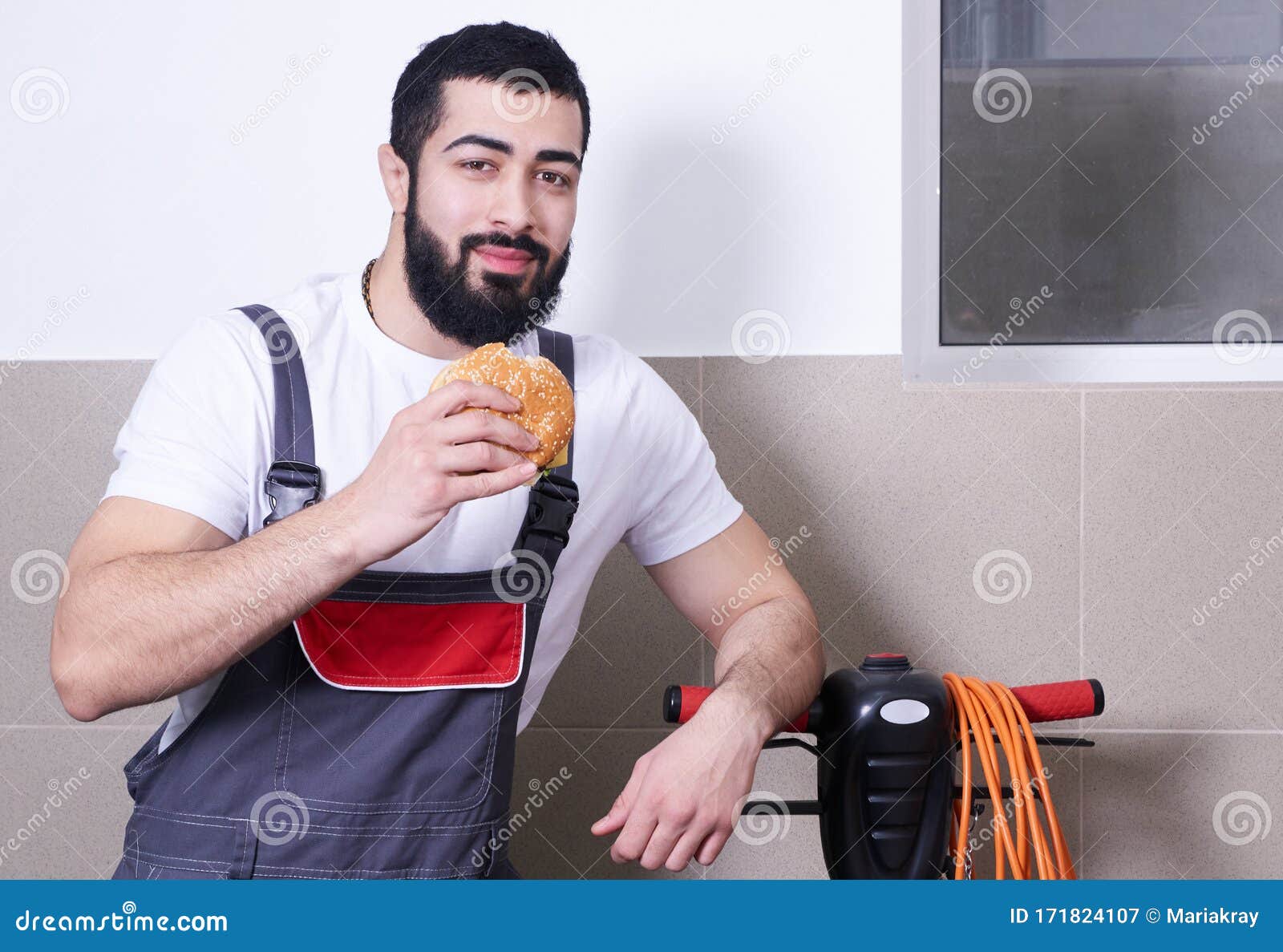 Worker Wearing Uniform Eating Burger during Lunch Break Stock Image ...