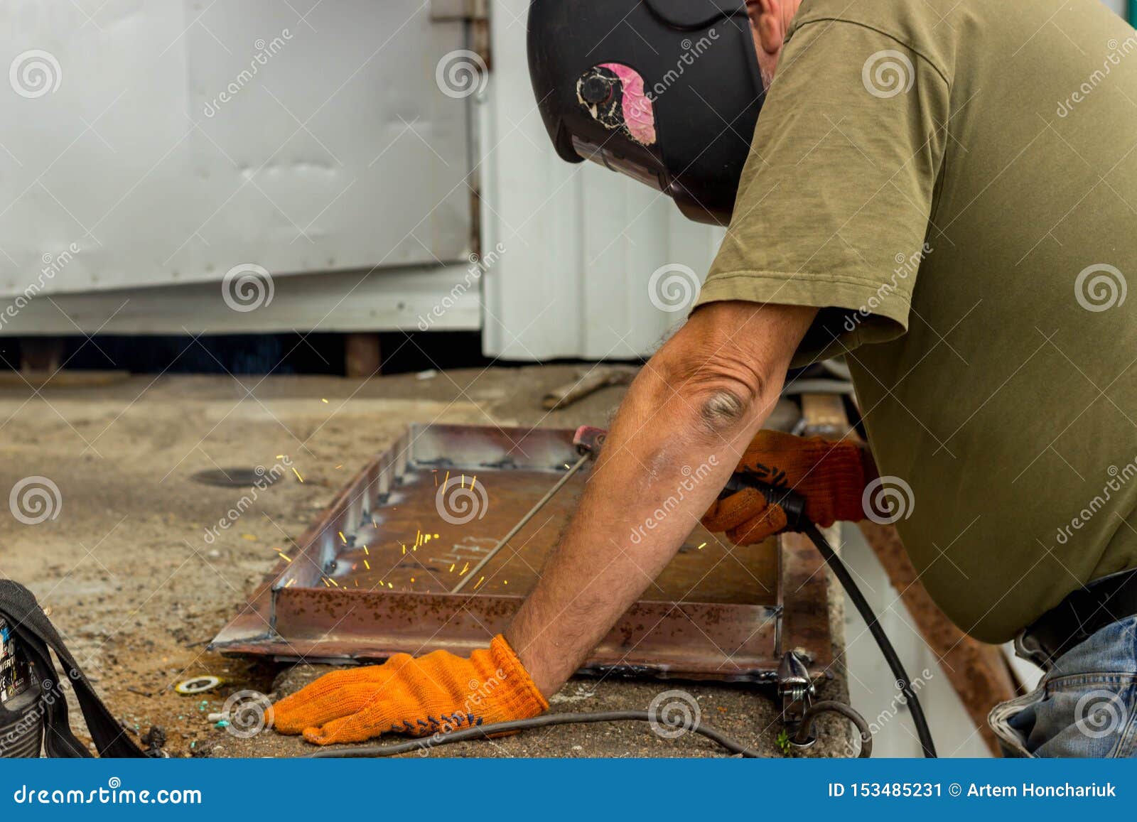 A Worker in a Welding Mask Performs Welding Work on the Metal. Bond ...