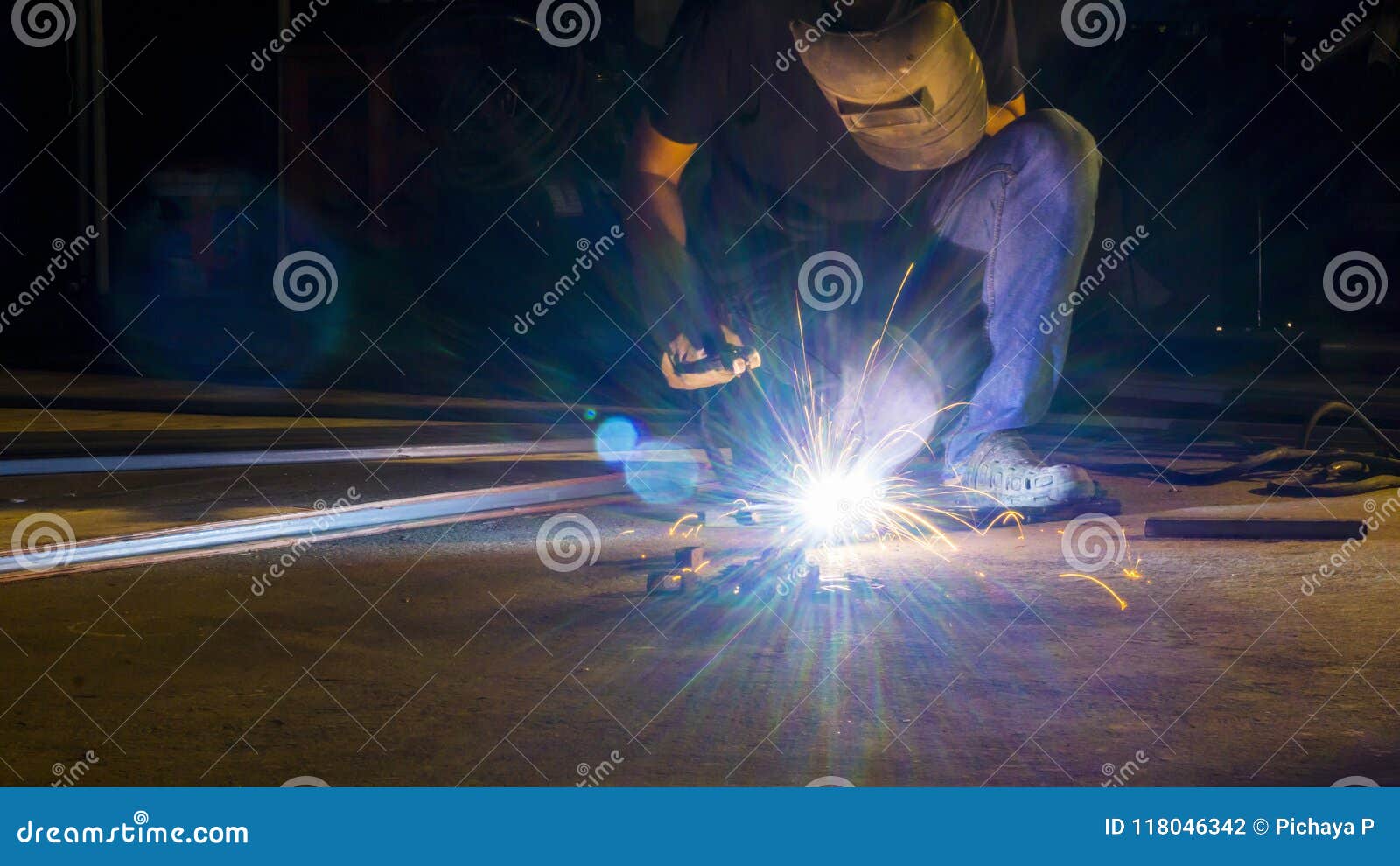 Worker Welding Metal, Focus on Flash Light Line of Sharp Spark,in Low ...