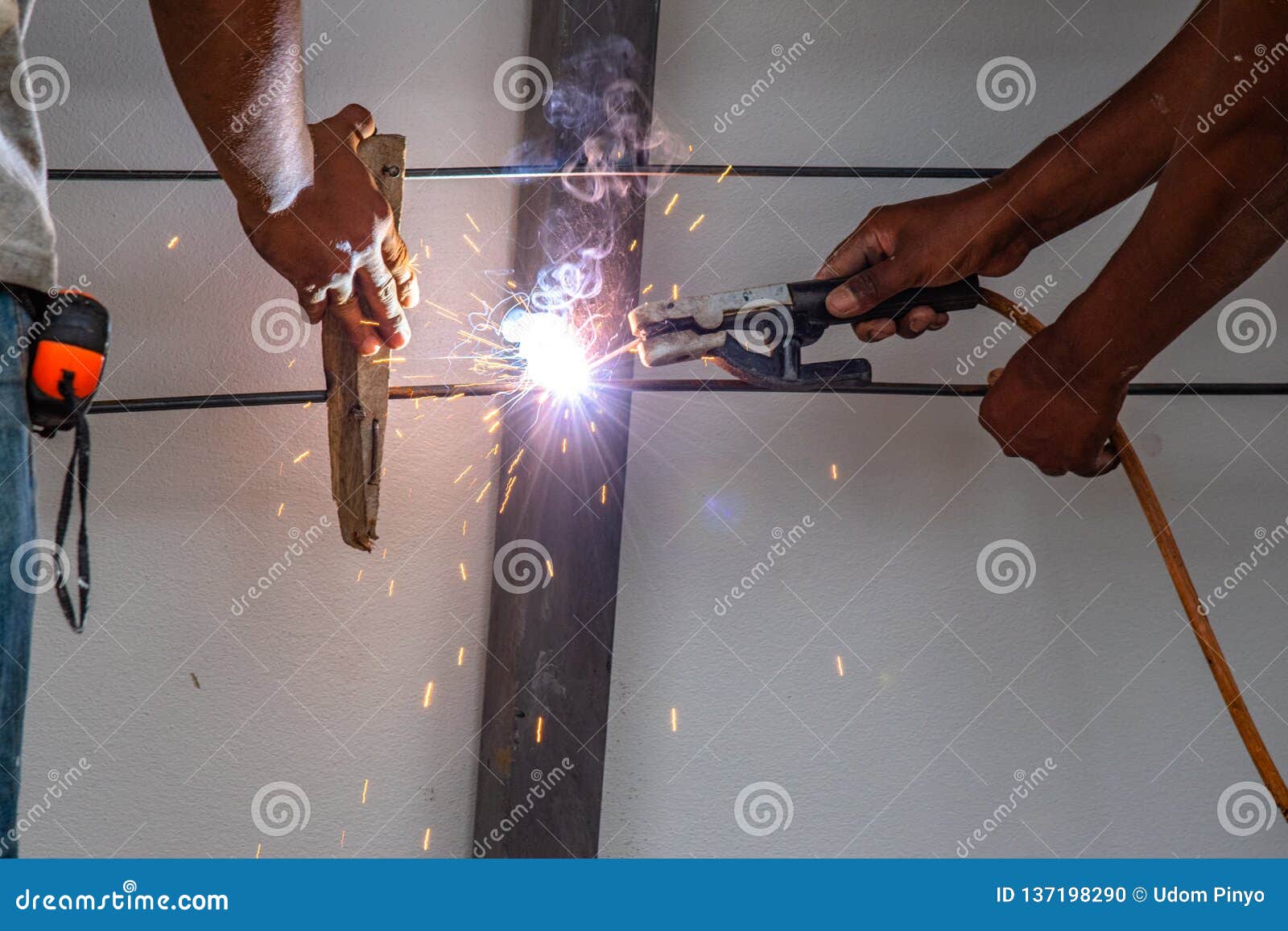 Worker welding steel bar. stock photo. Image of iron - 137198290