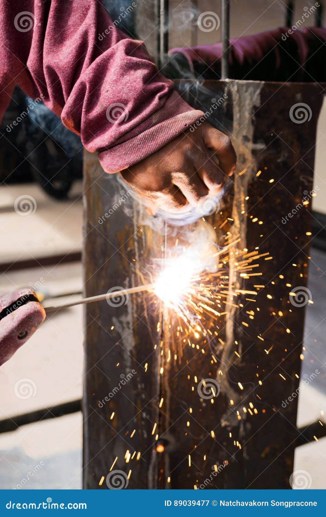 Worker Welding Steel with Spark Lighting and Smoke at Construction Site ...