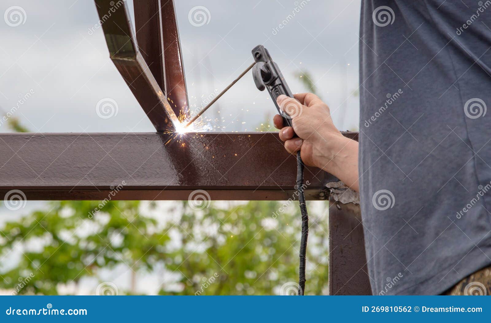 A Worker Welds Metal at a Construction Site. Stock Photo - Image of ...