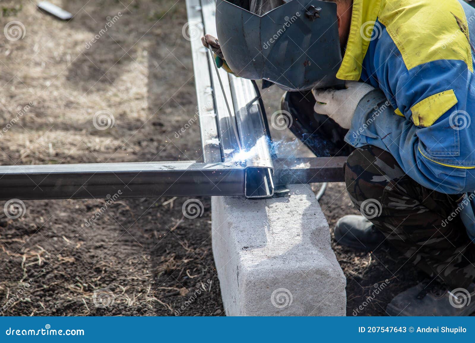 A Worker Welds Metal at a Construction Site. Technology Stock Image ...
