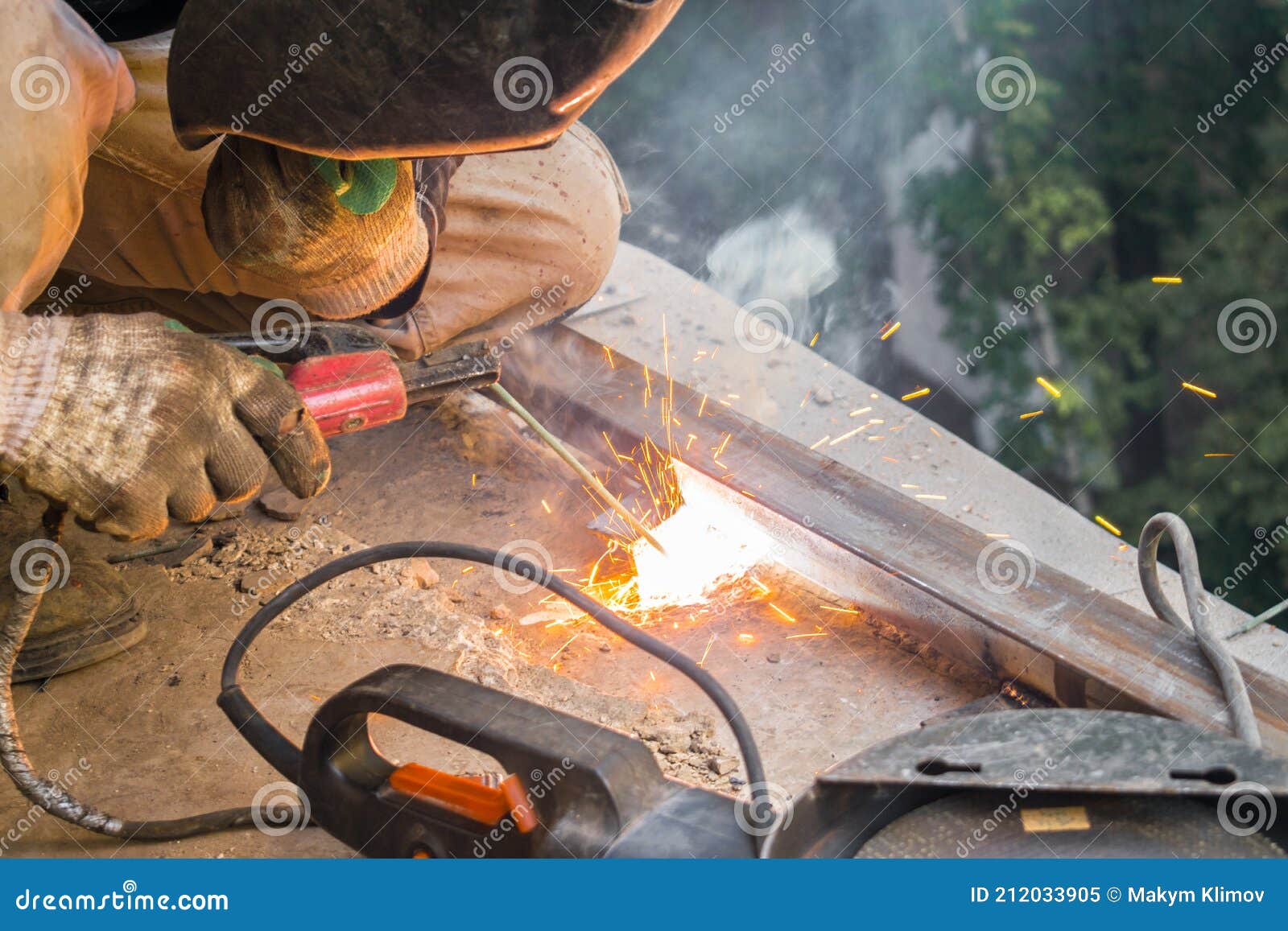 The Worker Welds the Metal Structure Using the Arc Welder. Work of ...
