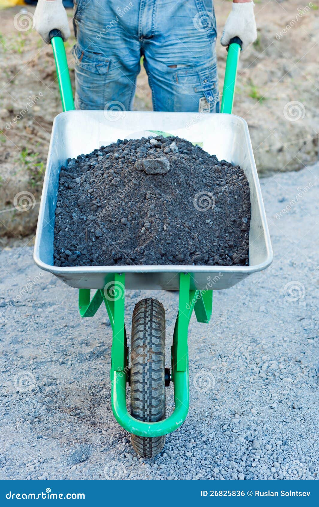 Worker with a wheelbarrow stock photo. Image of gloves - 26825836