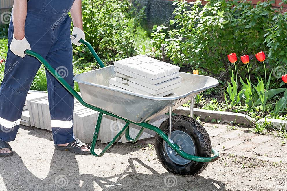 Worker with a wheelbarrow stock photo. Image of manual - 42444532