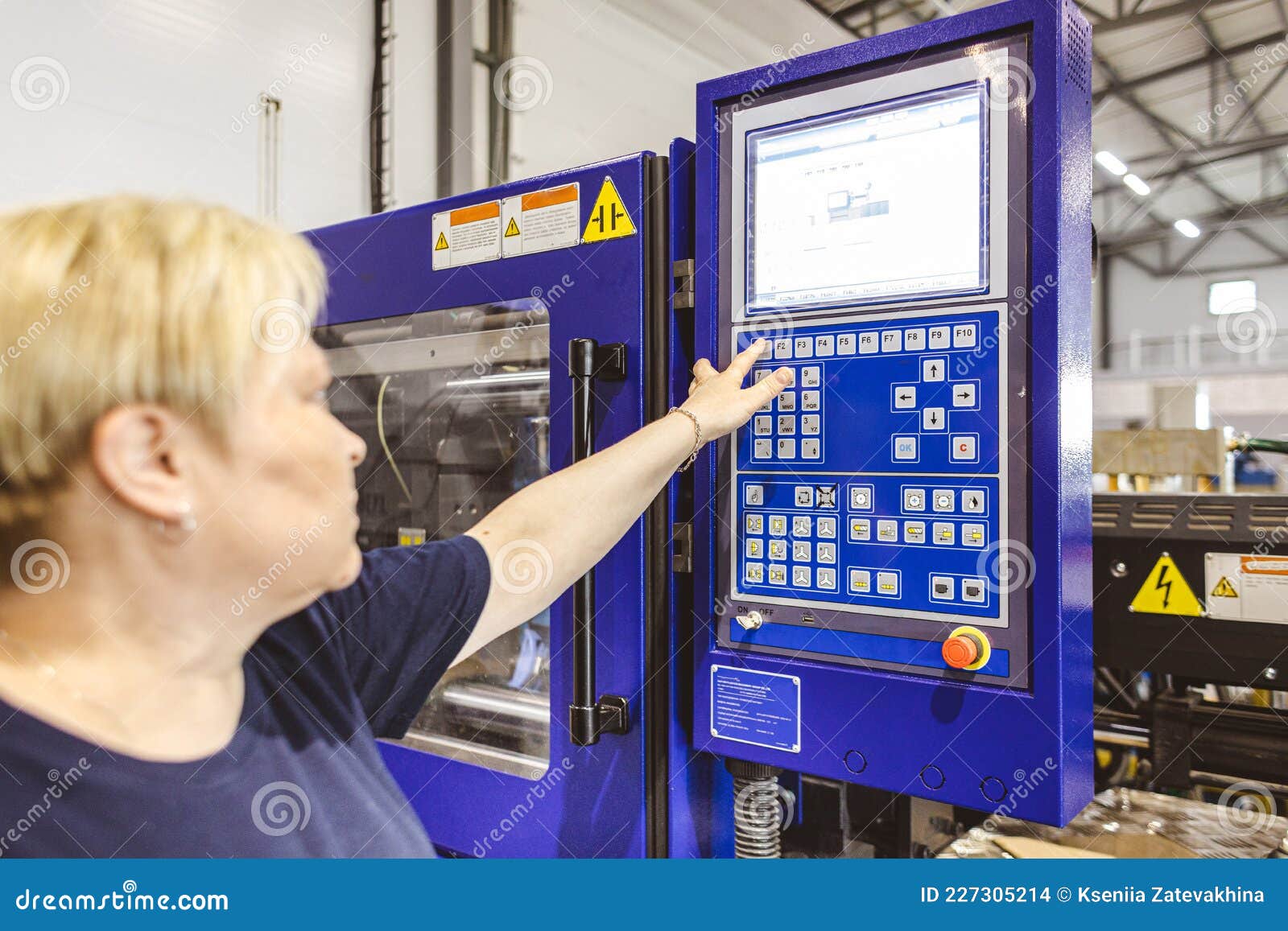 A Worker Woman Presses a Button and Starts an Automatic Manufacturing ...