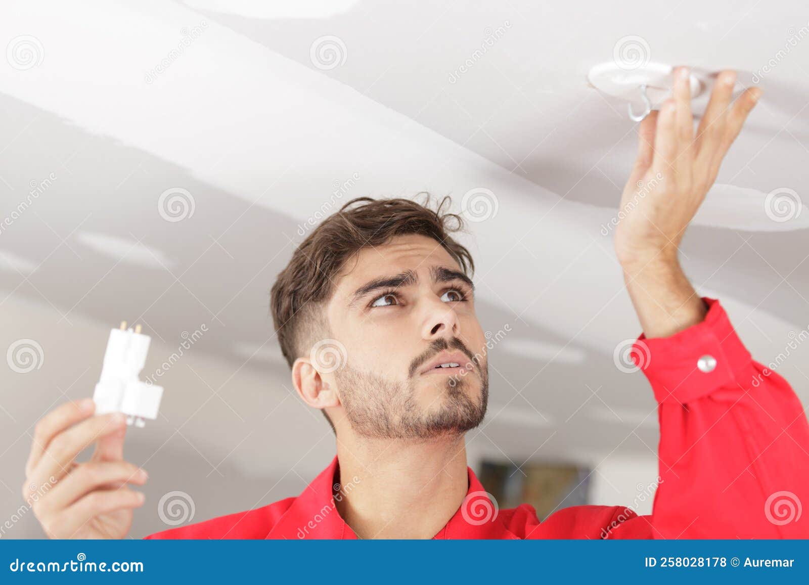 Worker working on ceiling stock photo. Image of tool - 258028178