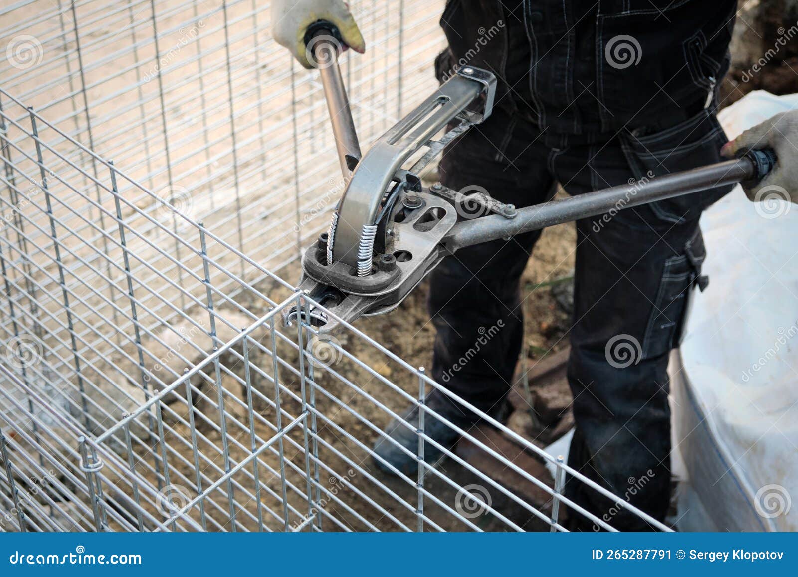 A Worker is Working on the Construction of a New House Using Large ...