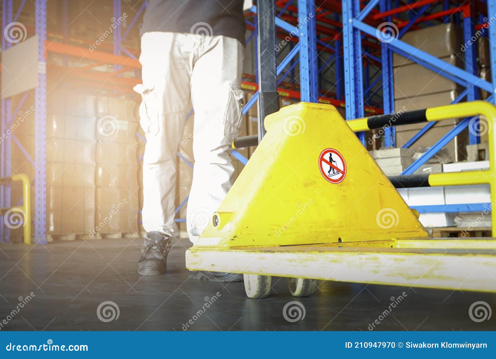 Worker Working with Hand Pallet Jack Unloading Cargo Boxes at the ...