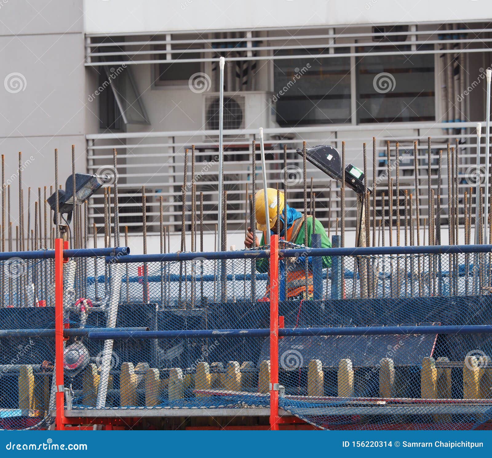 A Worker is Working on High Contruction Area, with Iron Wire Structure ...