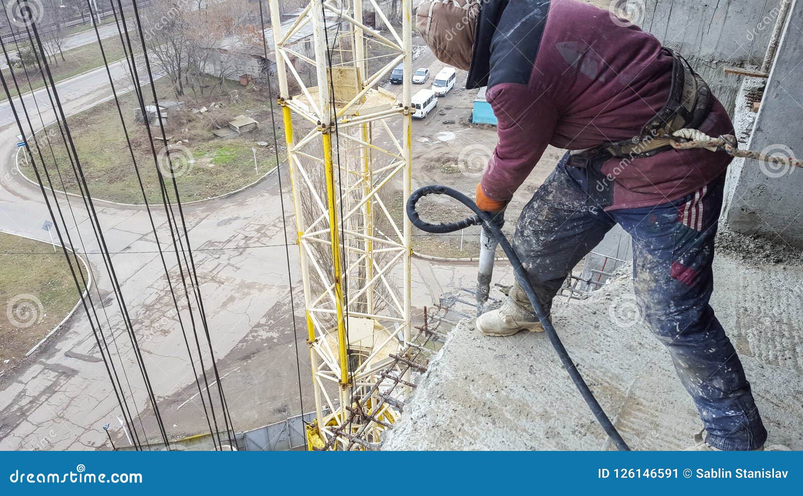 The Worker Works at the Construction Site with a Pneumatic Jackhammer ...