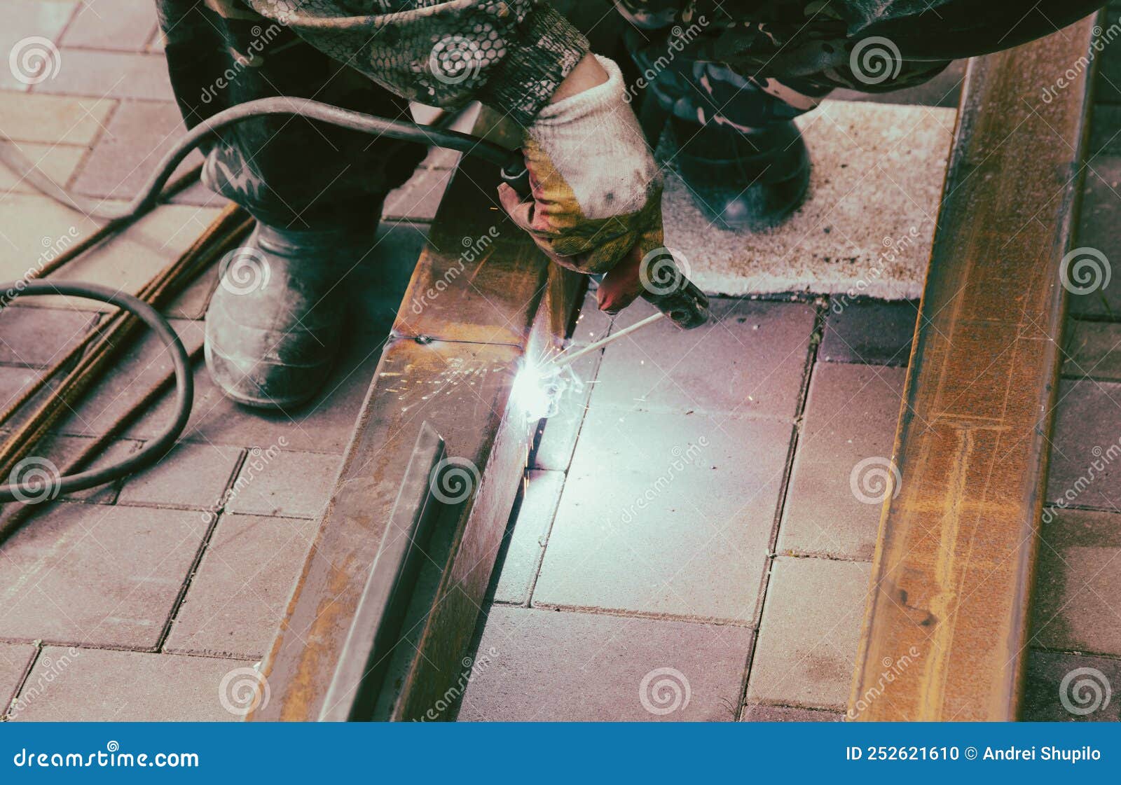 A Worker Works with Metal Welding at a Construction Site. Stock Photo ...