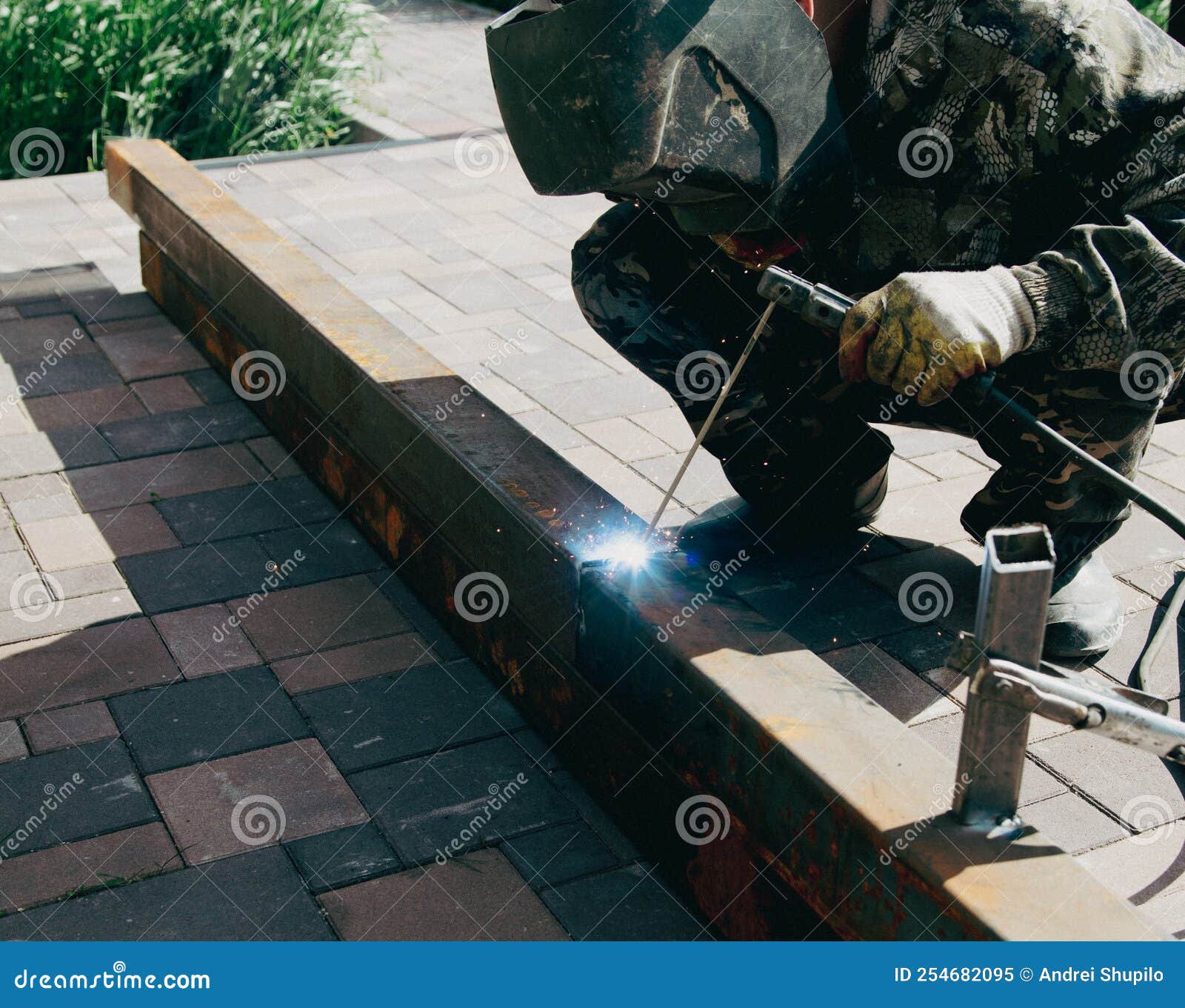 A Worker Works with Metal Welding at a Construction Site. Stock Image ...