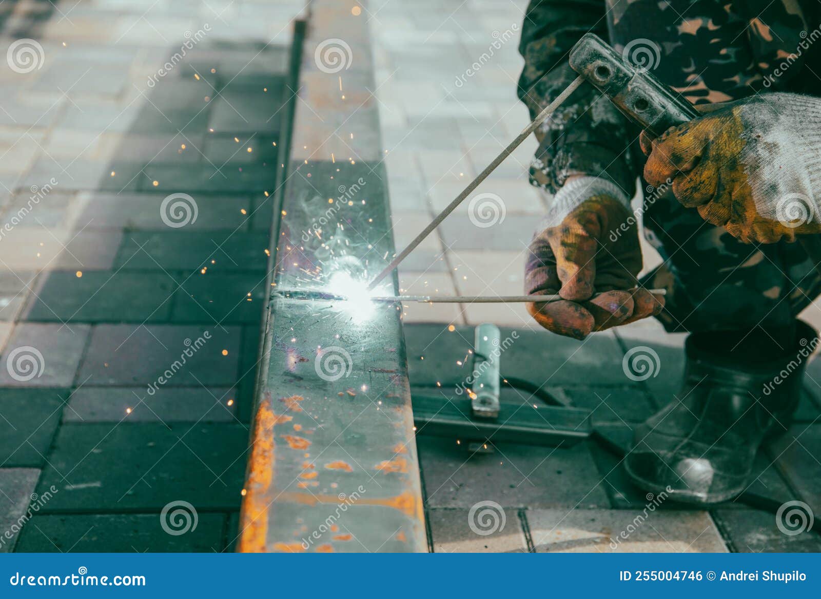 A Worker Works with Metal Welding at a Construction Site. Stock Photo ...
