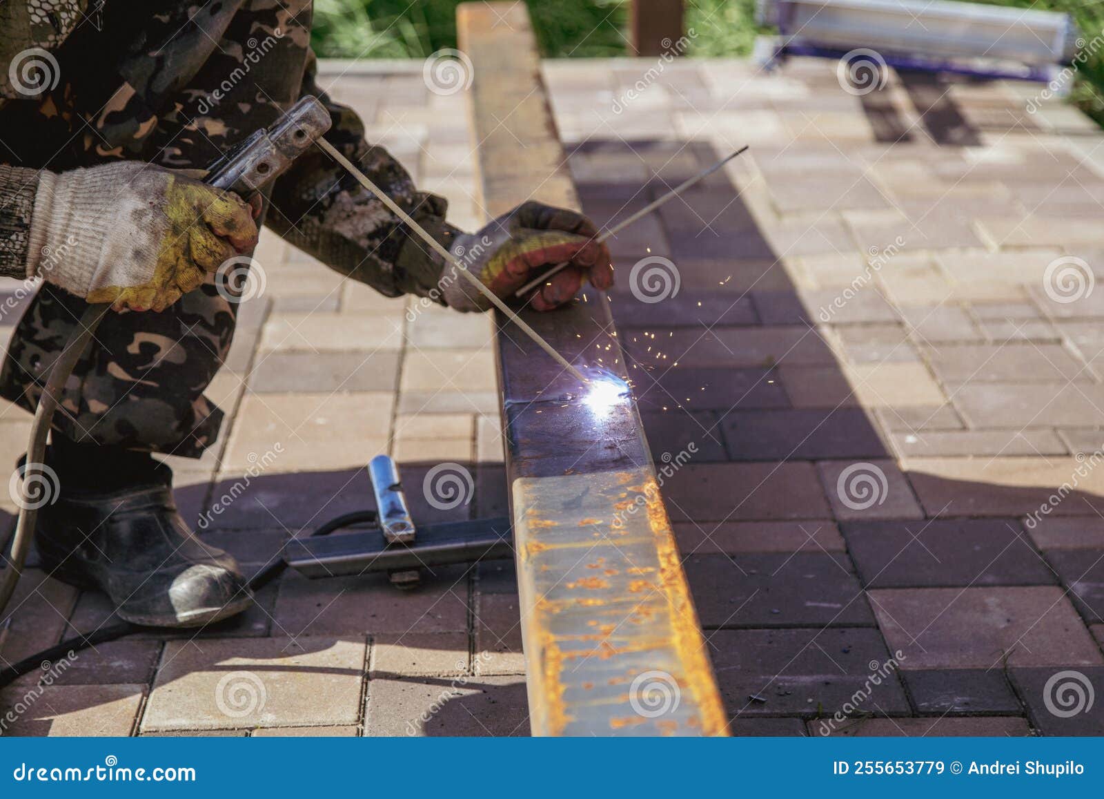 A Worker Works with Metal Welding at a Construction Site. Stock Image ...