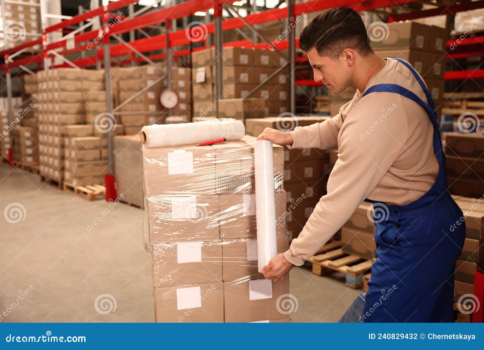 Worker Wrapping Boxes in Stretch Film at Warehouse Stock Photo - Image ...